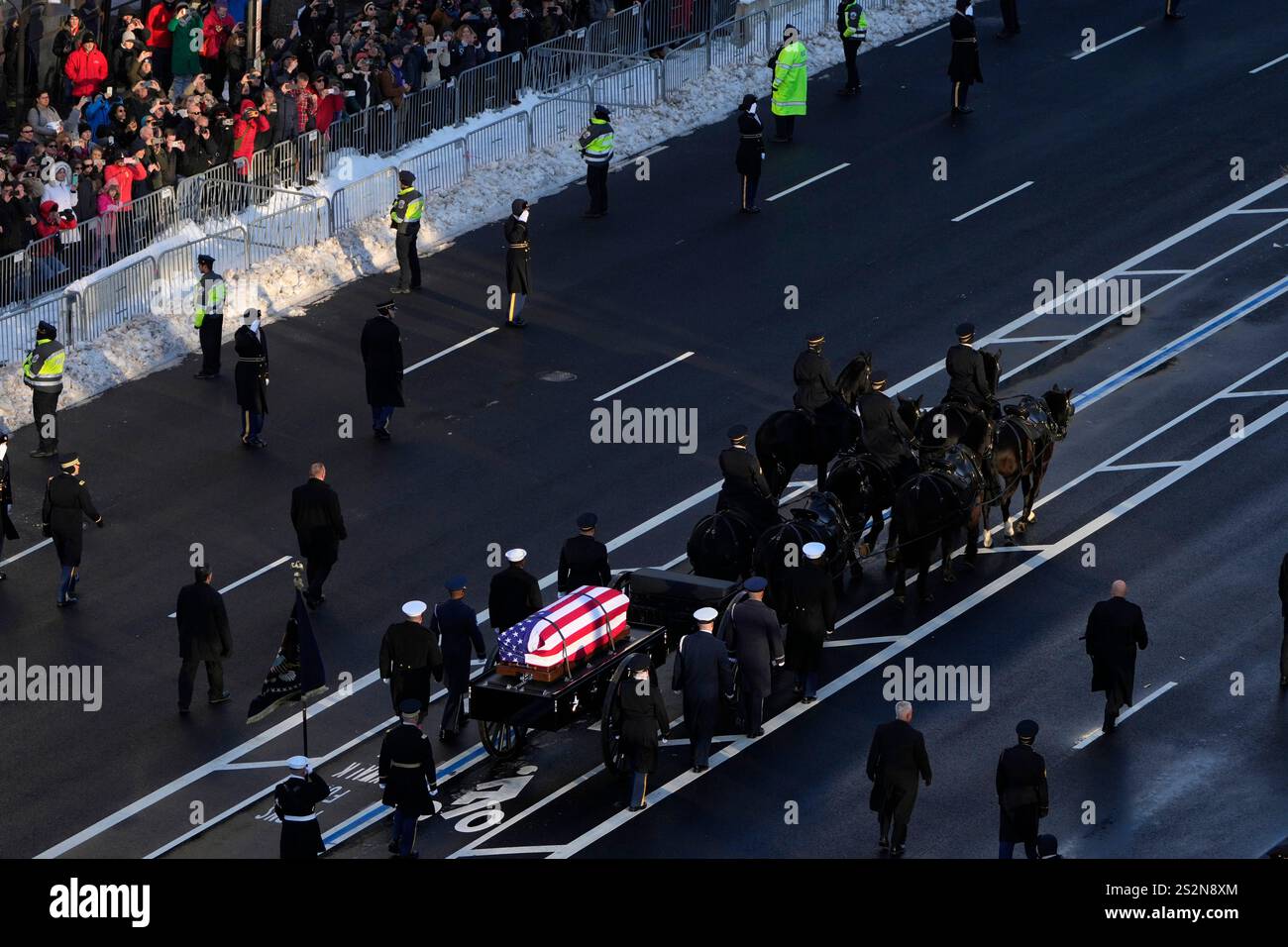 The flag-draped casket of former President Jimmy Carter travels in a ...