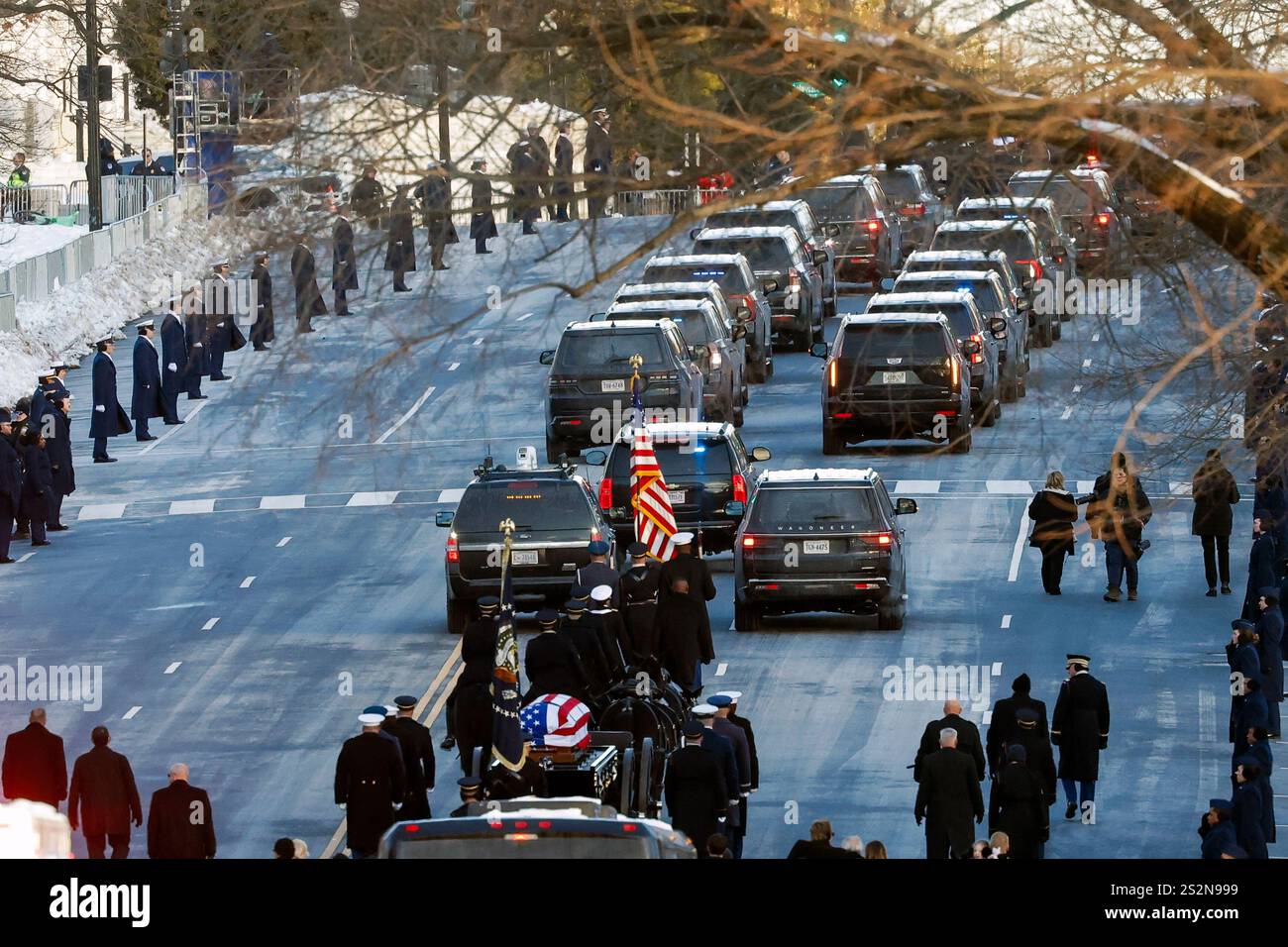 The flag-draped casket of former President Jimmy Carter moves toward ...