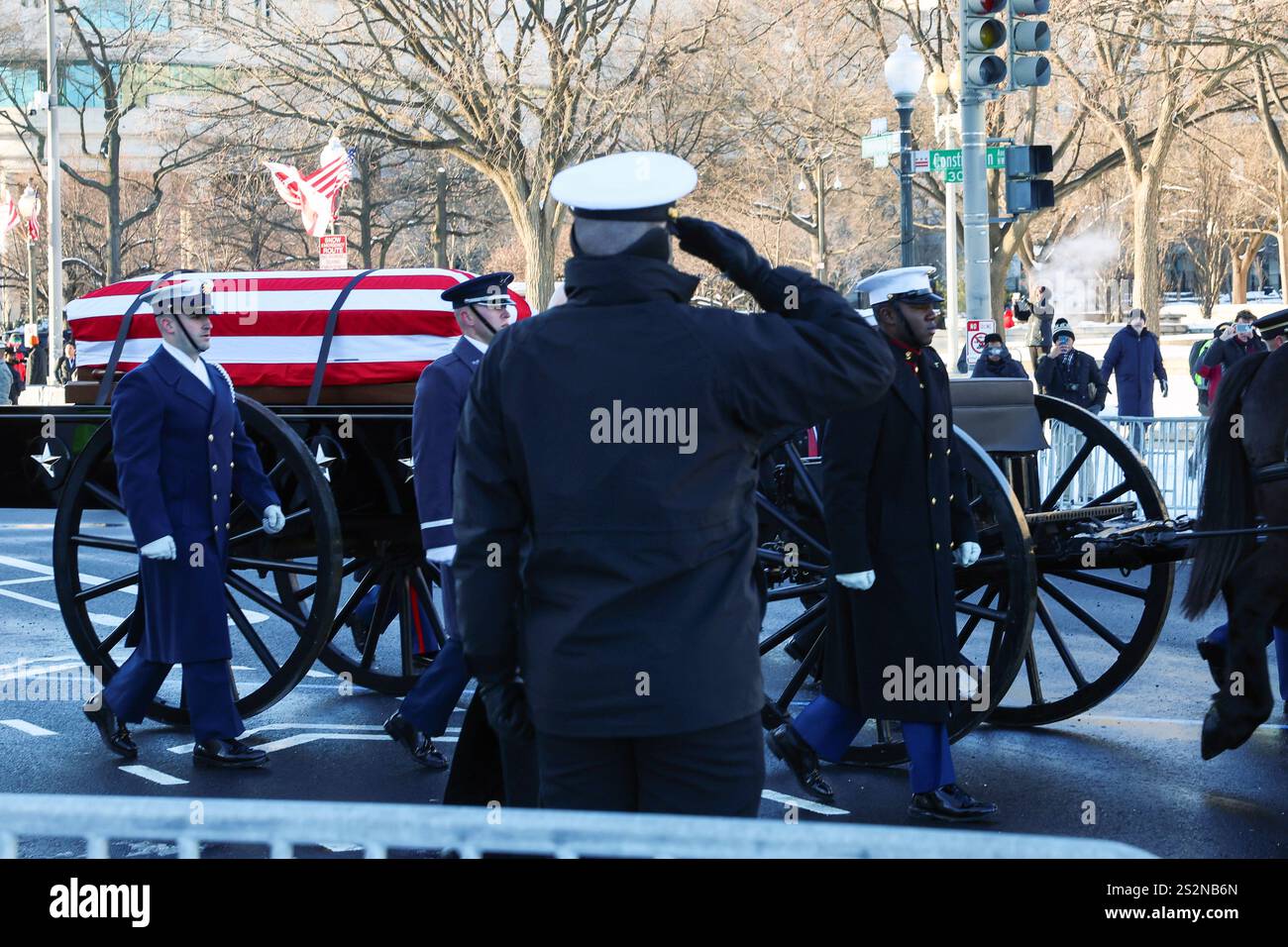 The flag-draped casket of former President Jimmy Carter moves toward ...