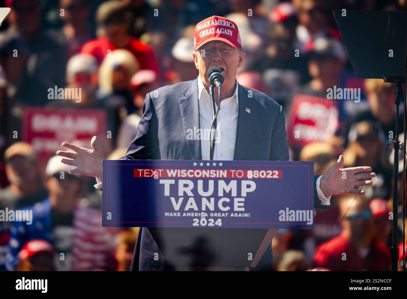 Donald Trump gives a speech behind bullet proof glass at an outdoor ...