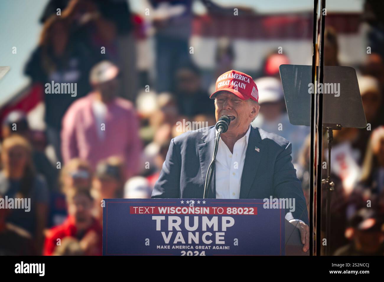 Donald Trump gives a speech behind bullet proof glass at an outdoor ...