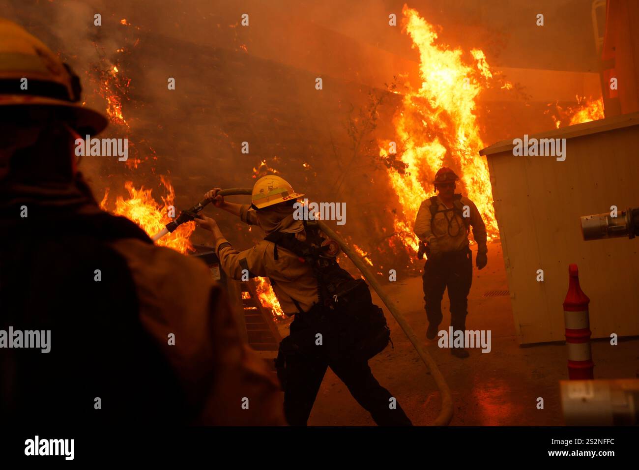 Firefighters protect structures from the advancing Palisades Fire in ...