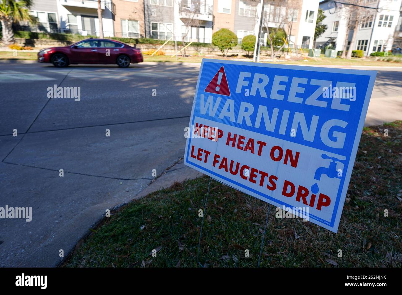 A freeze warning sign is stands outside of an apartment complex ahead ...