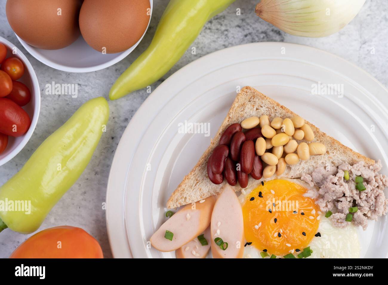 Breakfast consists of fried eggs, sausage, minced pork, bread, red ...