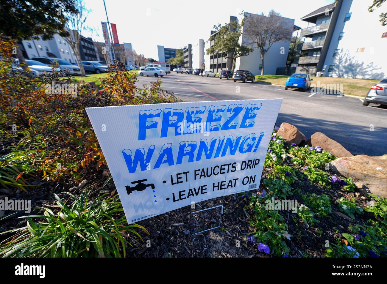 A freeze warning sign is stands outside of an apartment complex ahead ...