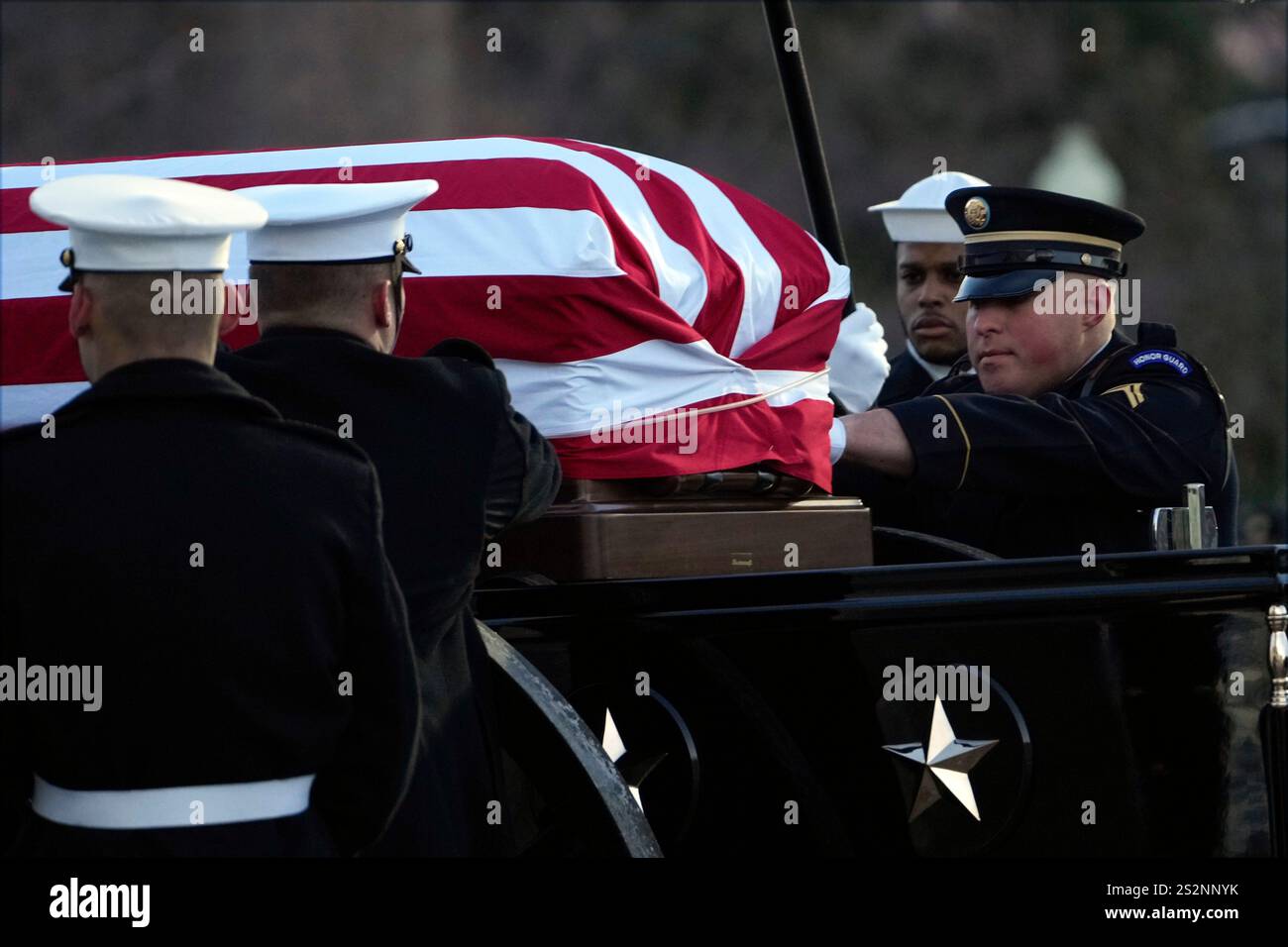 The flag-draped casket of former President Jimmy Carter rests on a ...
