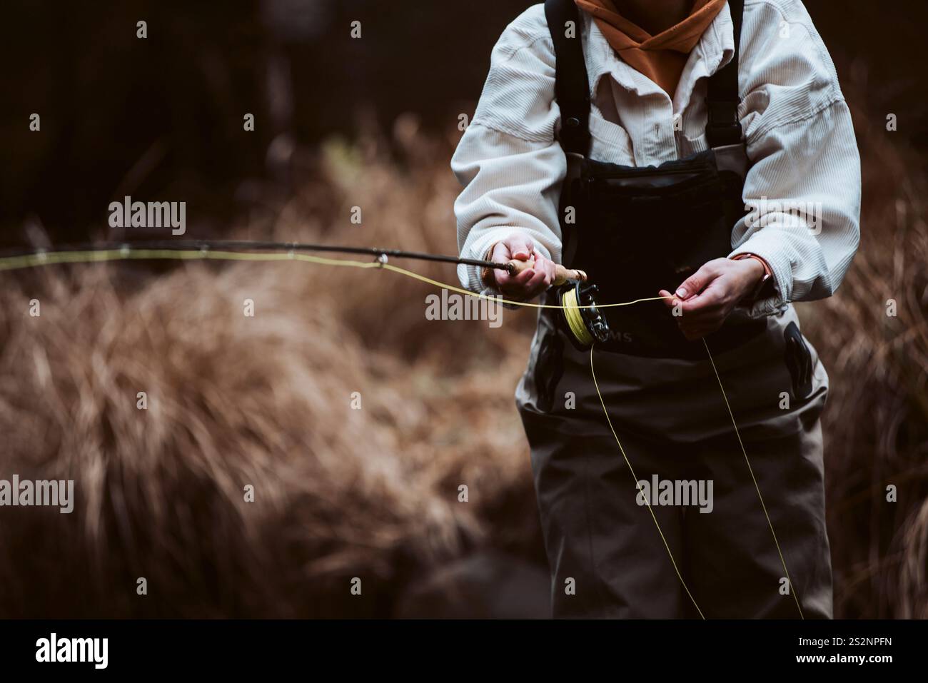 Woman holding fishing rod Stock Photo - Alamy