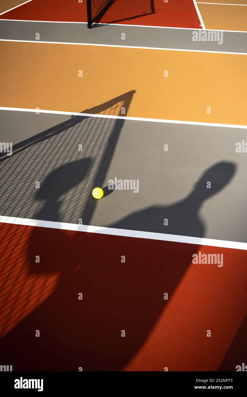 Human shadow holding pickle ball paddle Stock Photo - Alamy