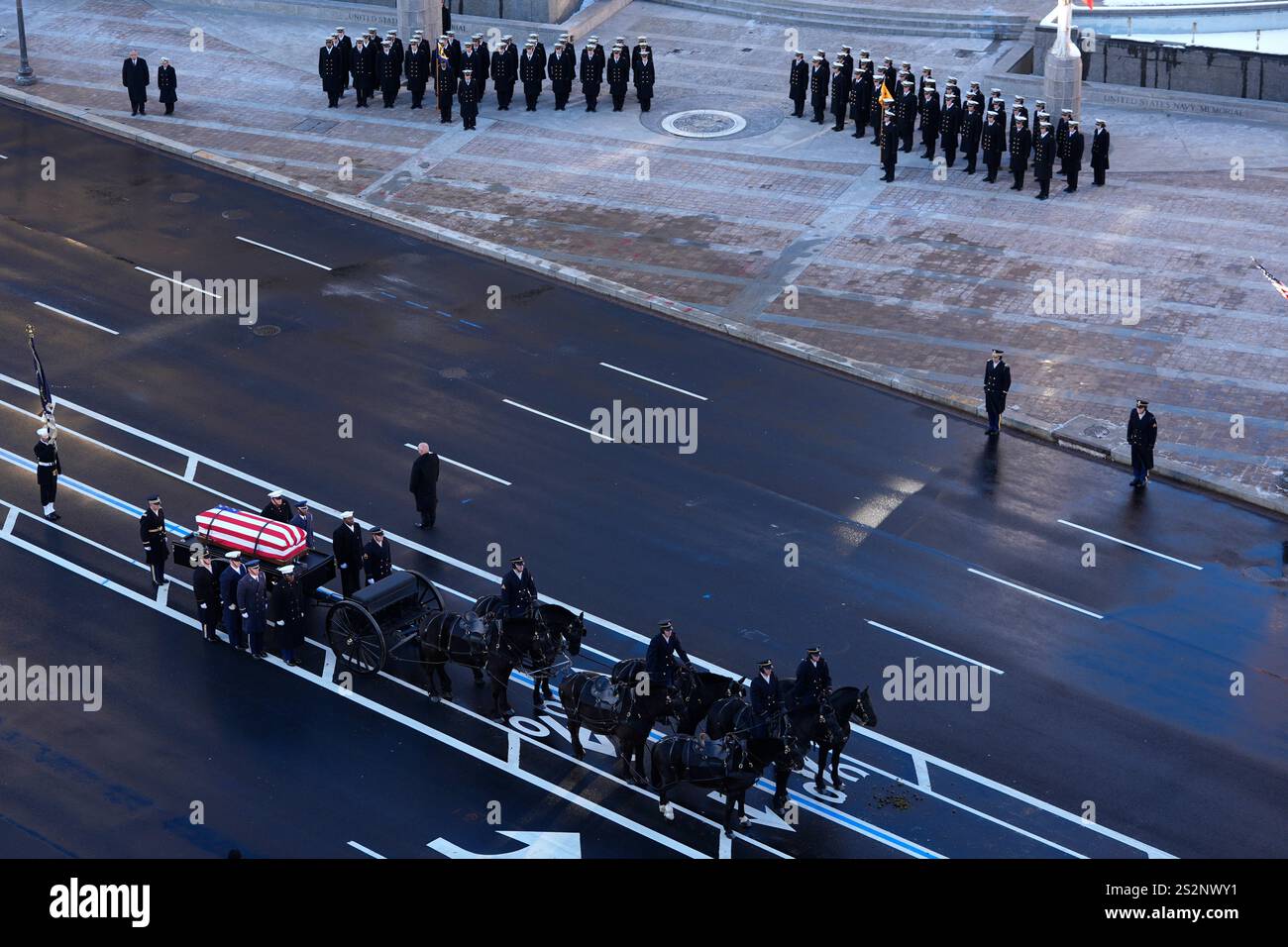 The flag-draped casket of former President Jimmy Carter travels in a ...