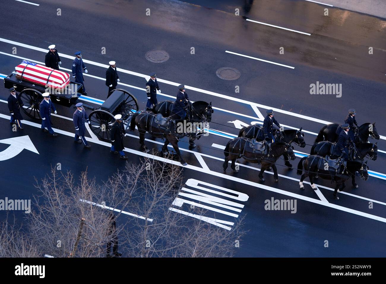 The flag-draped casket of former President Jimmy Carter travels in a ...