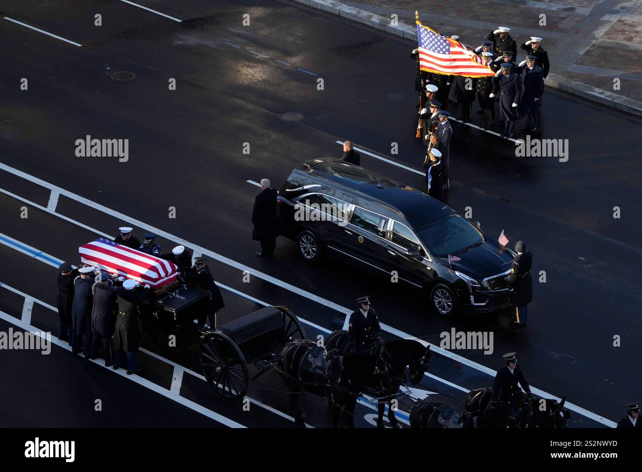 The flag-draped casket of former President Jimmy Carter is transferred ...