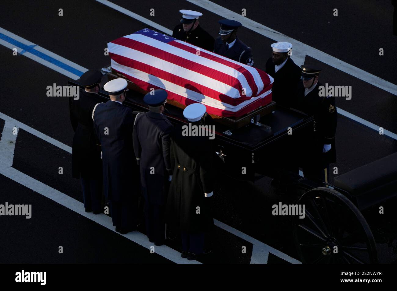 The flag-draped casket of former President Jimmy Carter is transferred ...