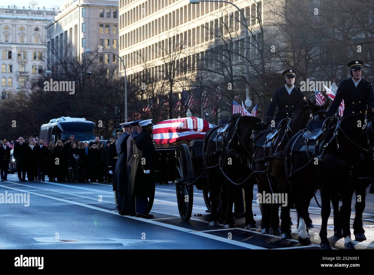 Members of the Carter family watch as the casket of former President ...
