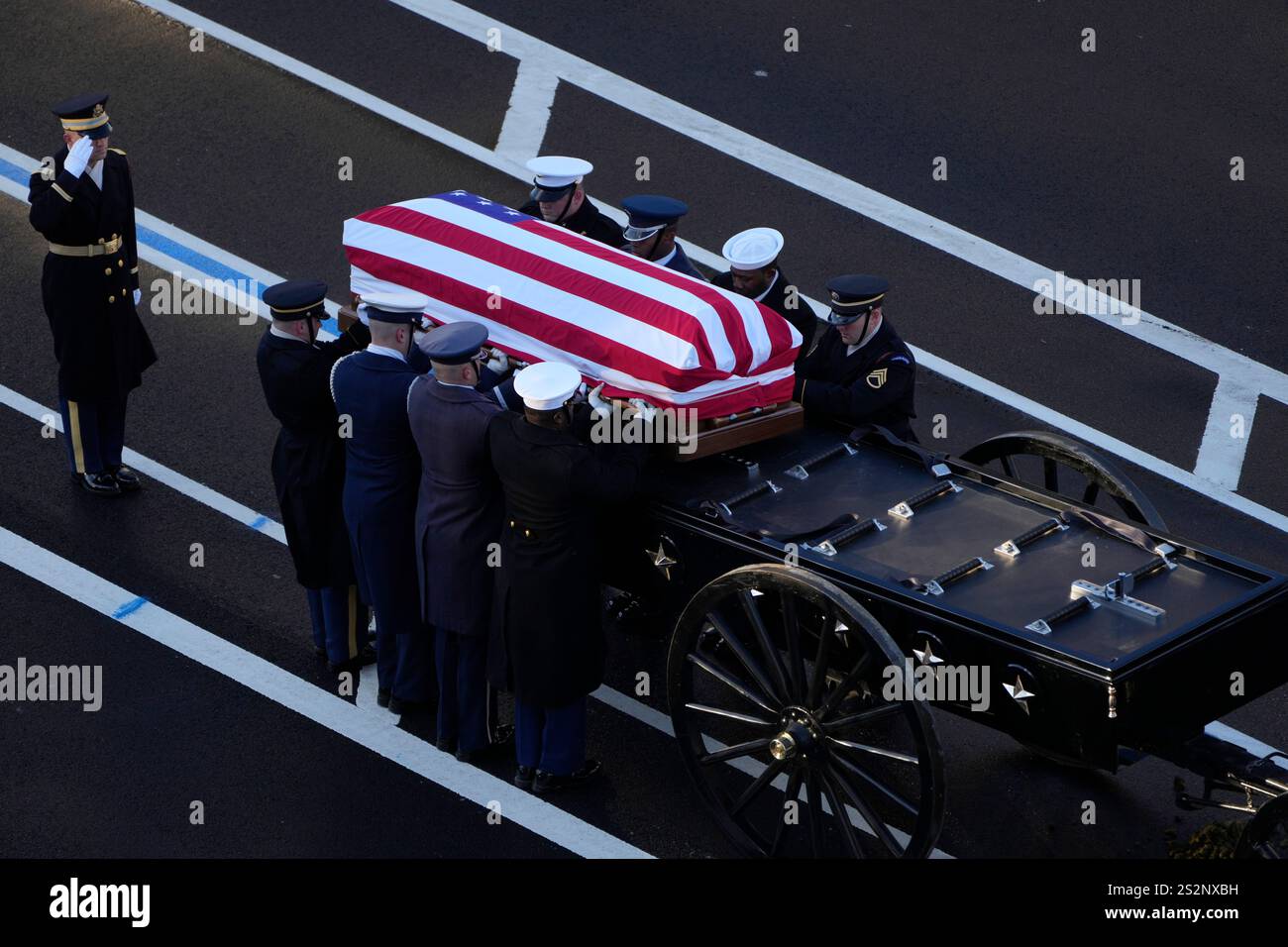 The flag-draped casket of former President Jimmy Carter is transferred ...