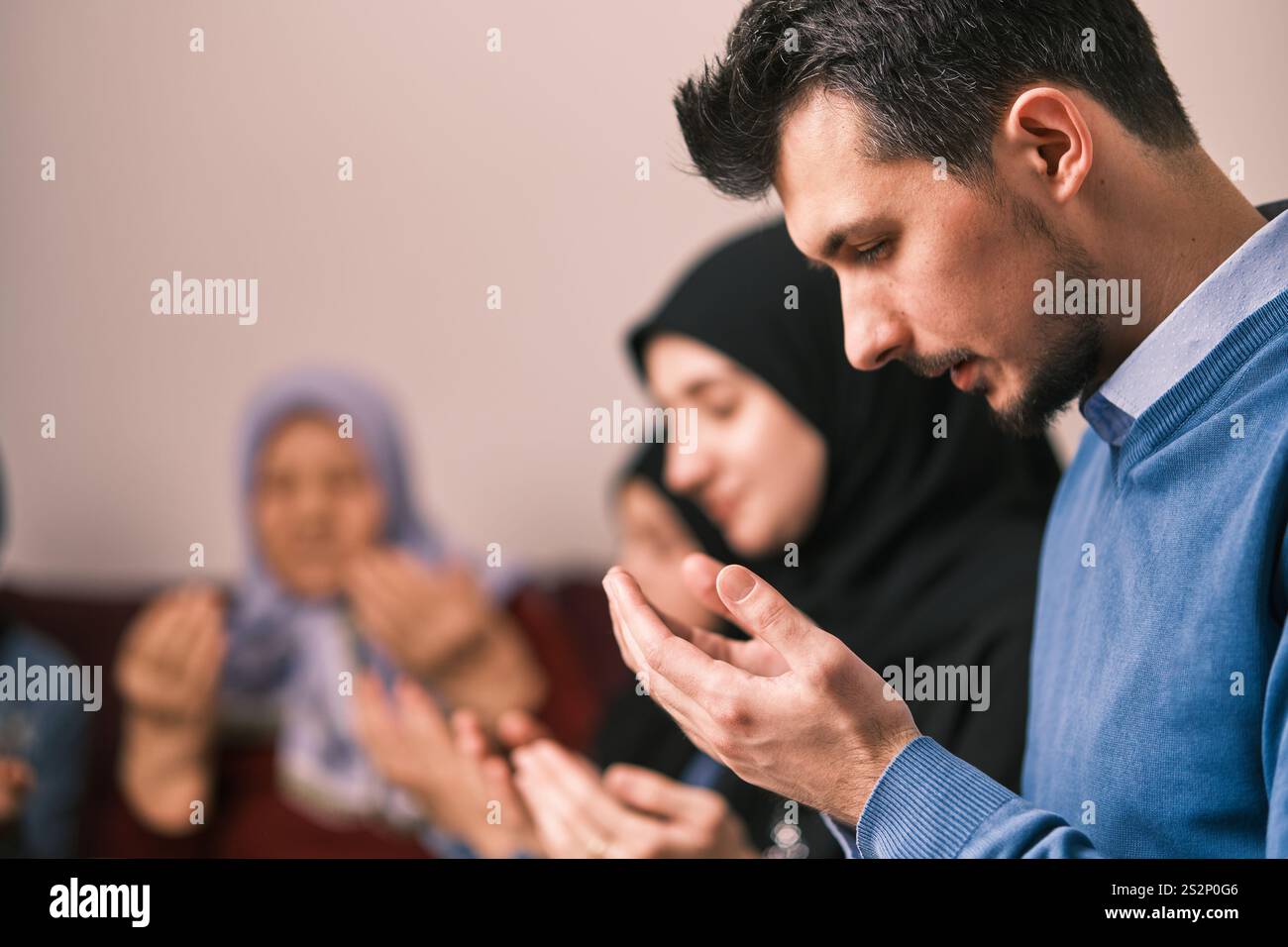 Muslim family making iftar dua to break fasting during Ramadan dining ...