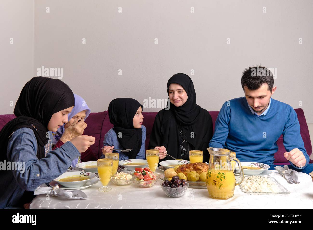 Happy Muslim family having iftar dinner during Ramadan dining table at ...