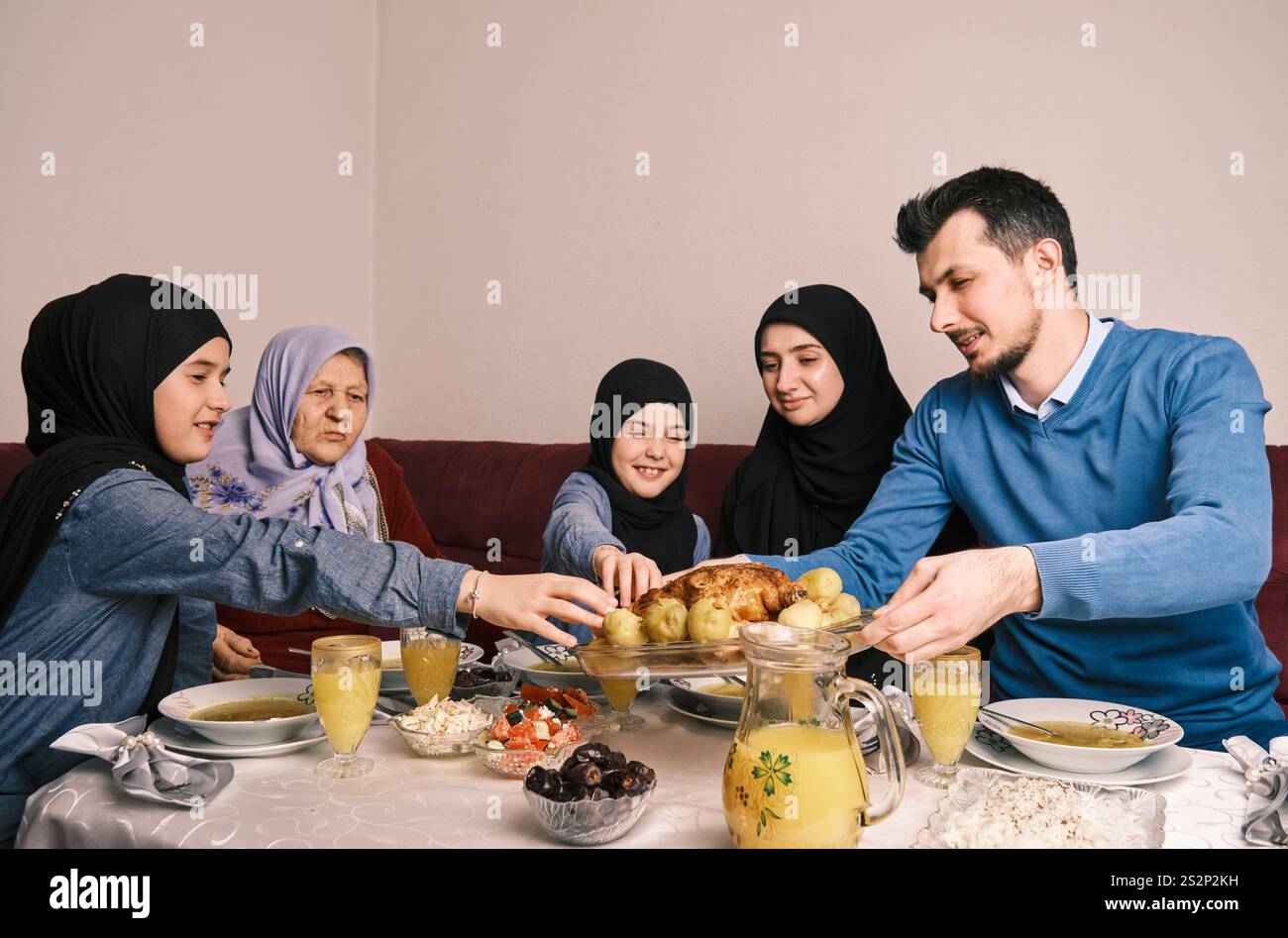 Happy Muslim family having iftar dinner during Ramadan dining table at ...