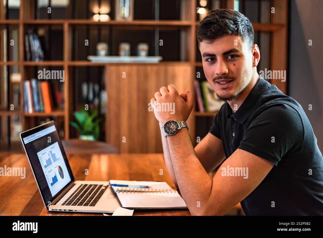 A male college student studying in a university library a young happy ...