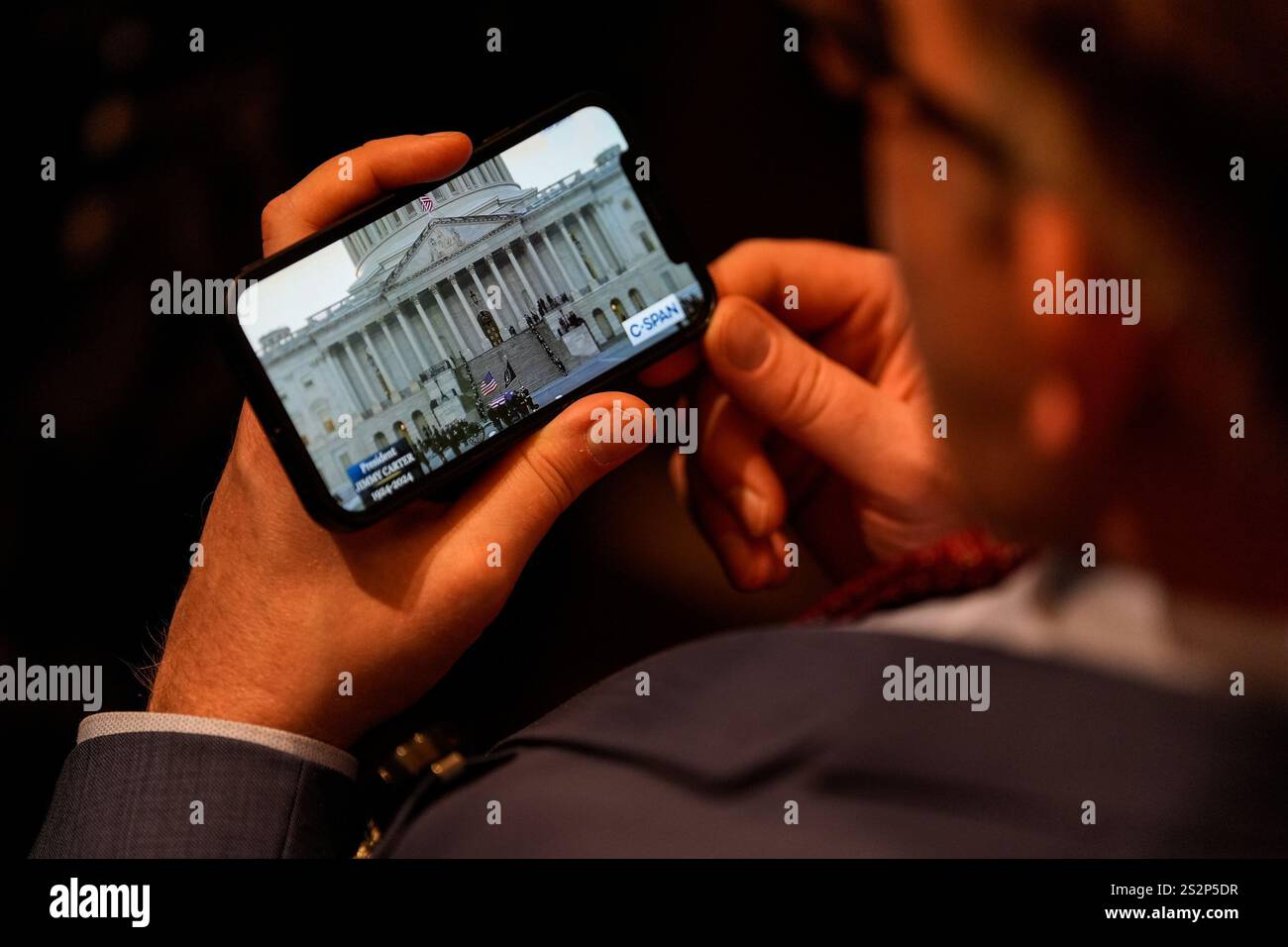 Washington, United States. 07th Jan, 2025. An attendee watches a C-SPAN ...
