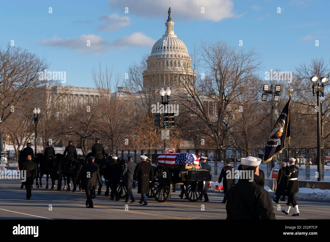 With the U.S. Capitol in the background the flag-draped casket of ...