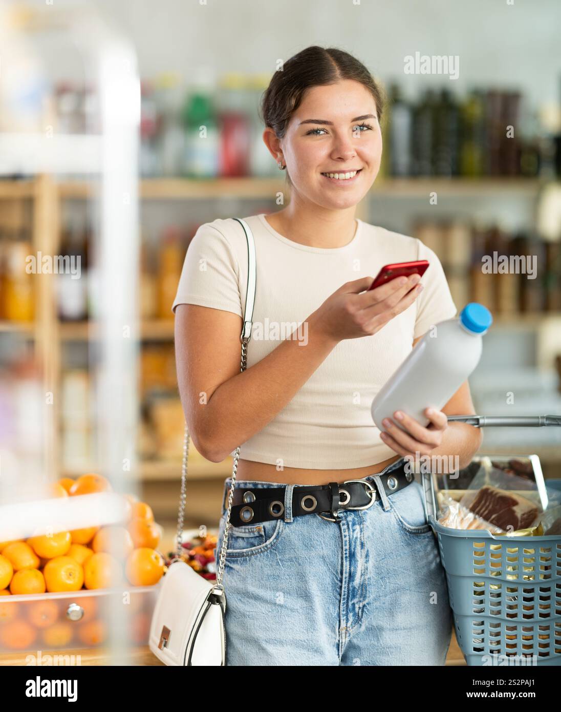 Young woman scanning qr code of milk Stock Photo - Alamy