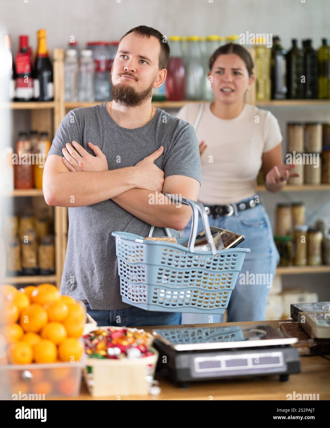 Young woman quarrels with man in grocery store Stock Photo - Alamy