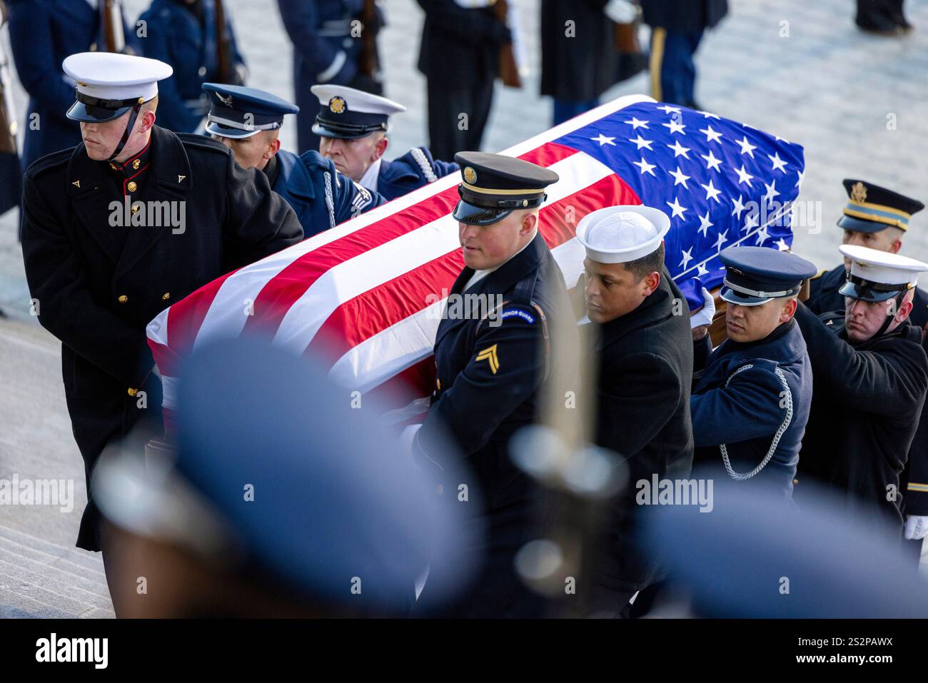 A joint services body bearer team moves the casket of former President ...