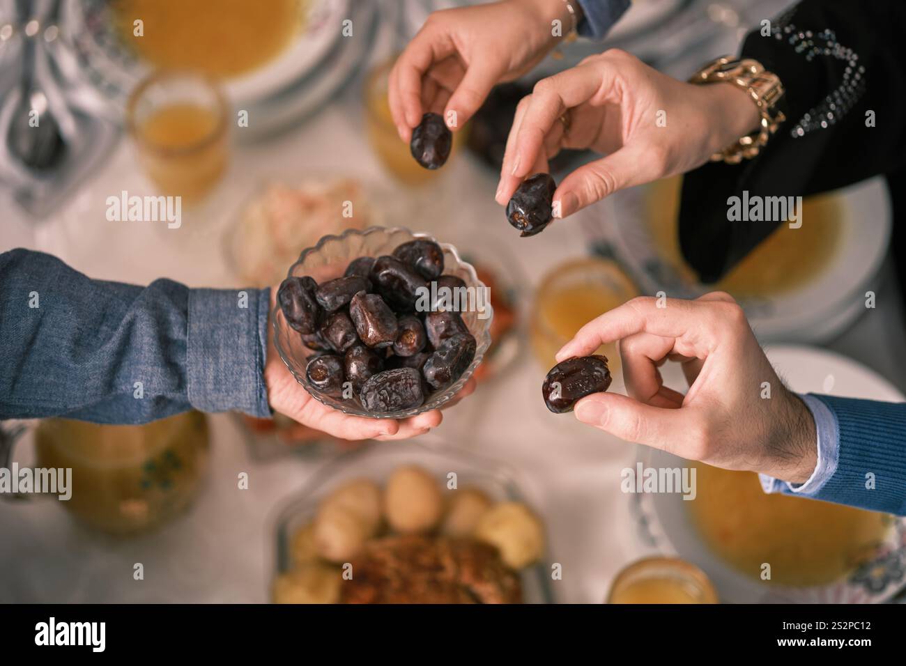 Happy Muslim family having iftar dinner to break fasting during Ramadan ...