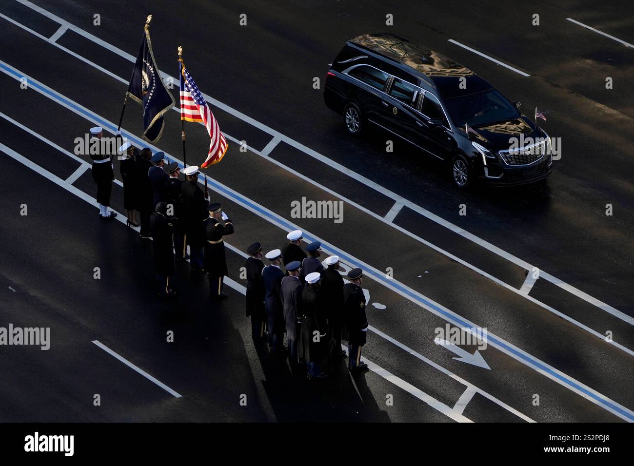 A hearse carrying the flag-draped casket of former President Jimmy ...