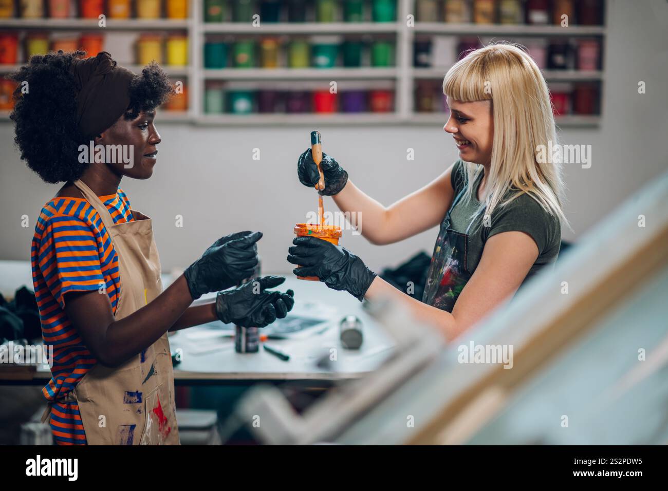 Side view of multicultural graphic technology experts standing at ...