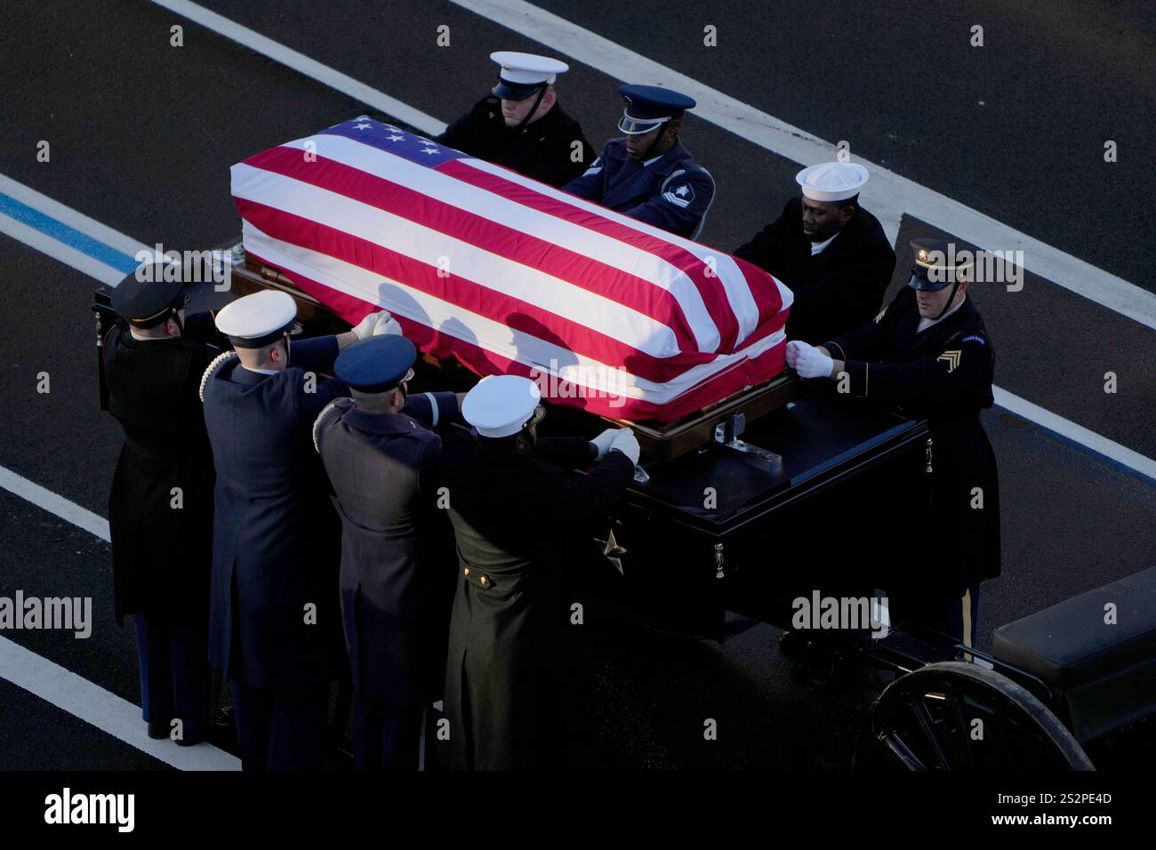 The flag-draped casket of former President Jimmy Carter is transferred ...