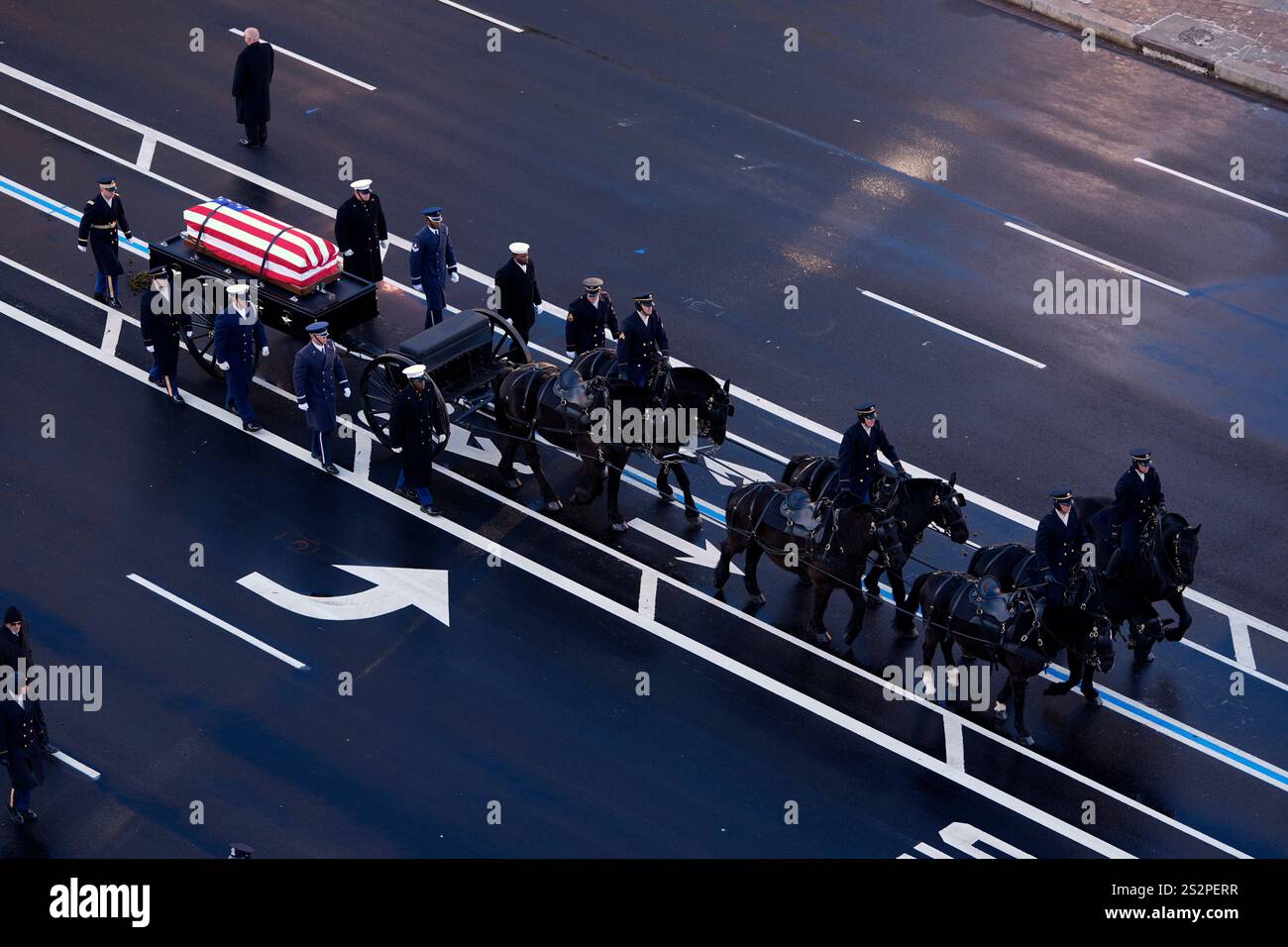 The flag-draped casket of former President Jimmy Carter travels in a ...