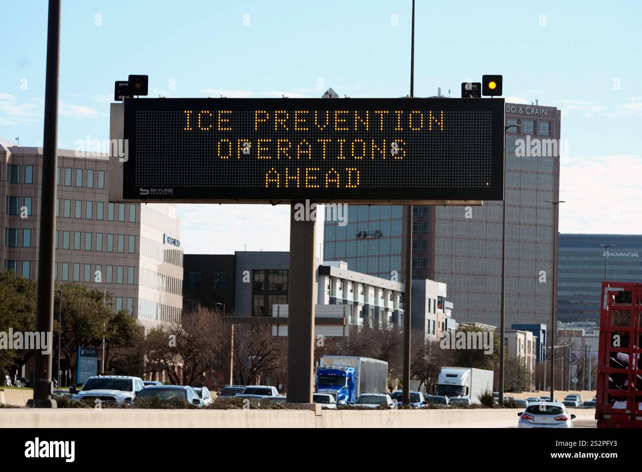A sign warns drivers of ice prevention operations ahead of a winter ...