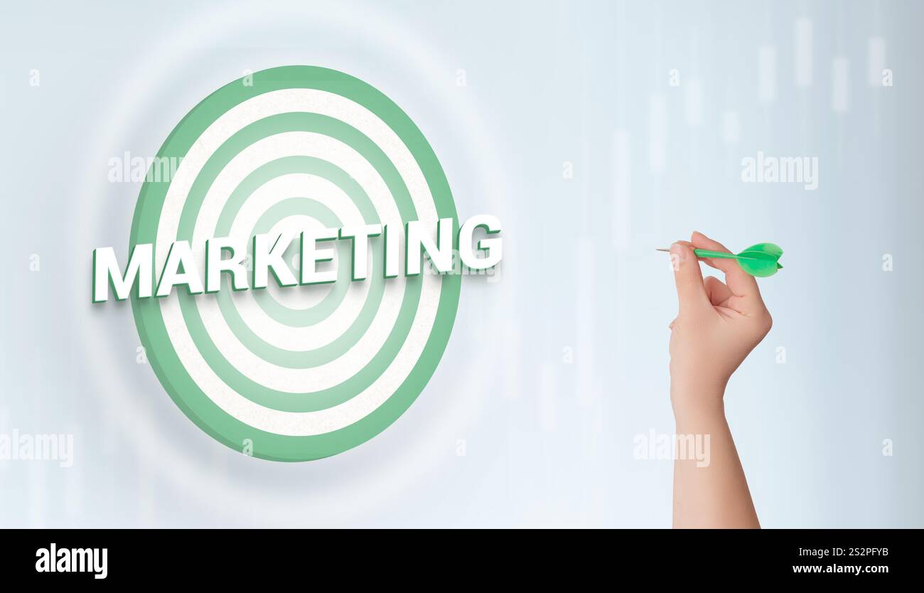 Hand holding a dart aiming at a target labeled Marketing. Symbolizing ...
