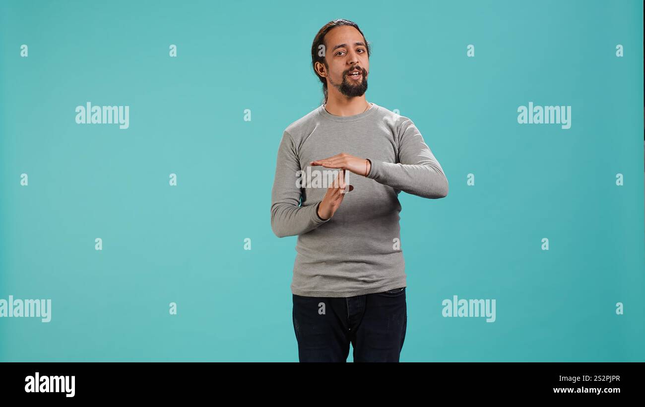 Portrait of assertive man asking for timeout, doing hand gestures ...