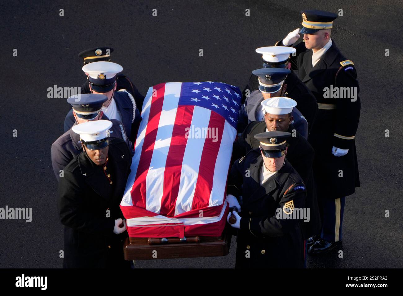 The flag-draped casket of former President Jimmy Carter is transferred ...