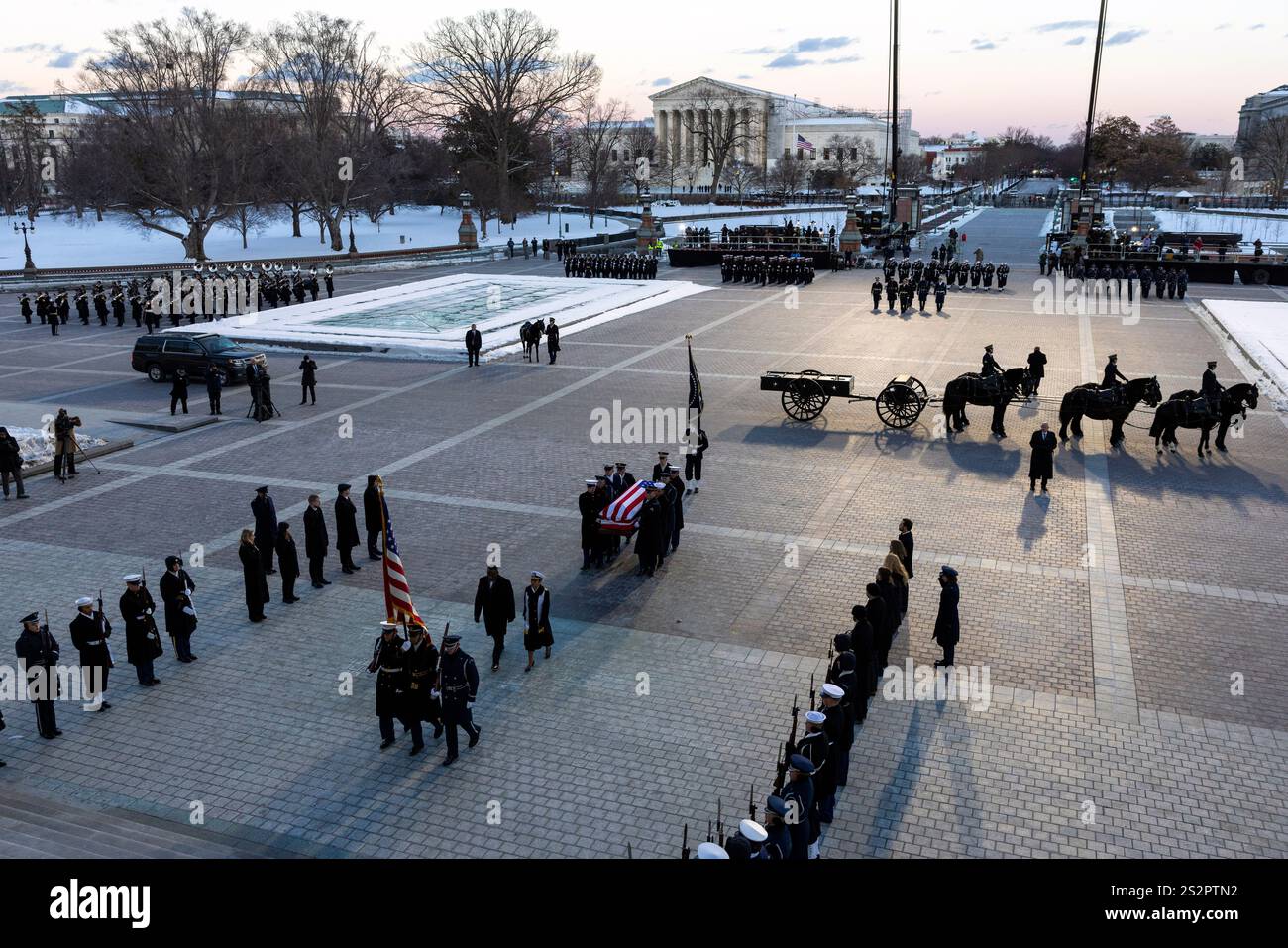A joint services body bearer team moves the casket of former President ...