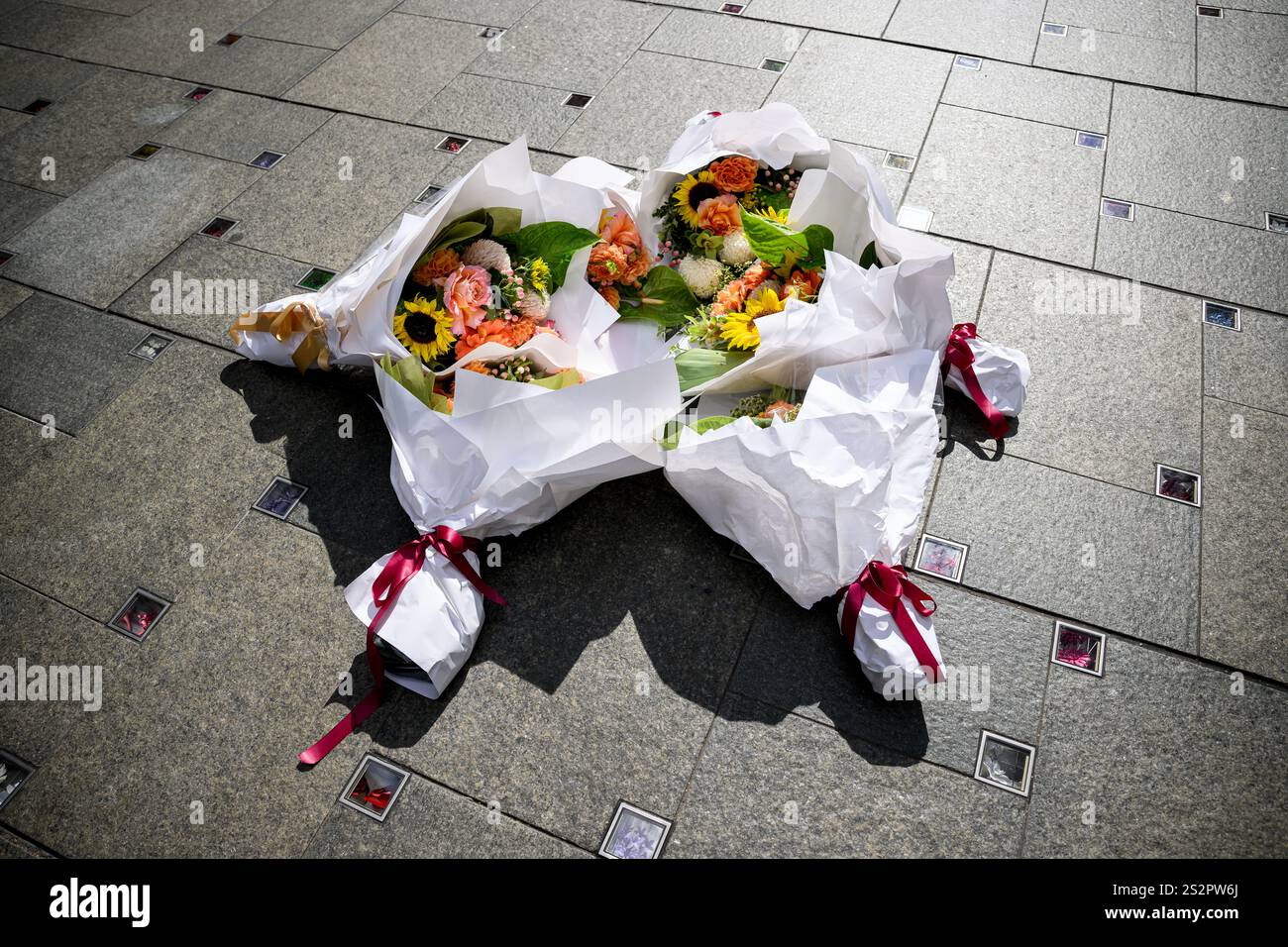 Floral tributes are left at the memorial for victim Tori Johnson, on ...