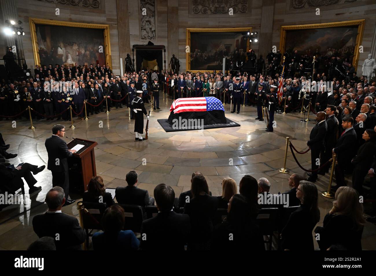 House Speaker Mike Johnson, left, delivers a eulogy for former ...