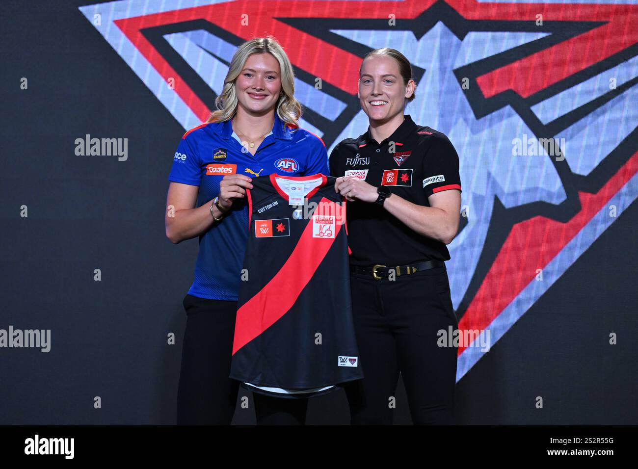 Melbourne, Australia. 16th Dec, 2024. Grace Belloni (left) is presented with a Essendon Bombers ...