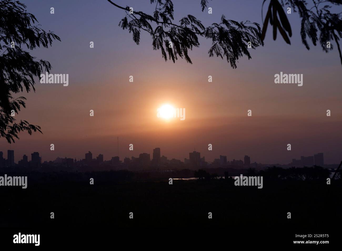 The sun sets in a smoke-filled sky caused by ranchers burning weeds, in ...
