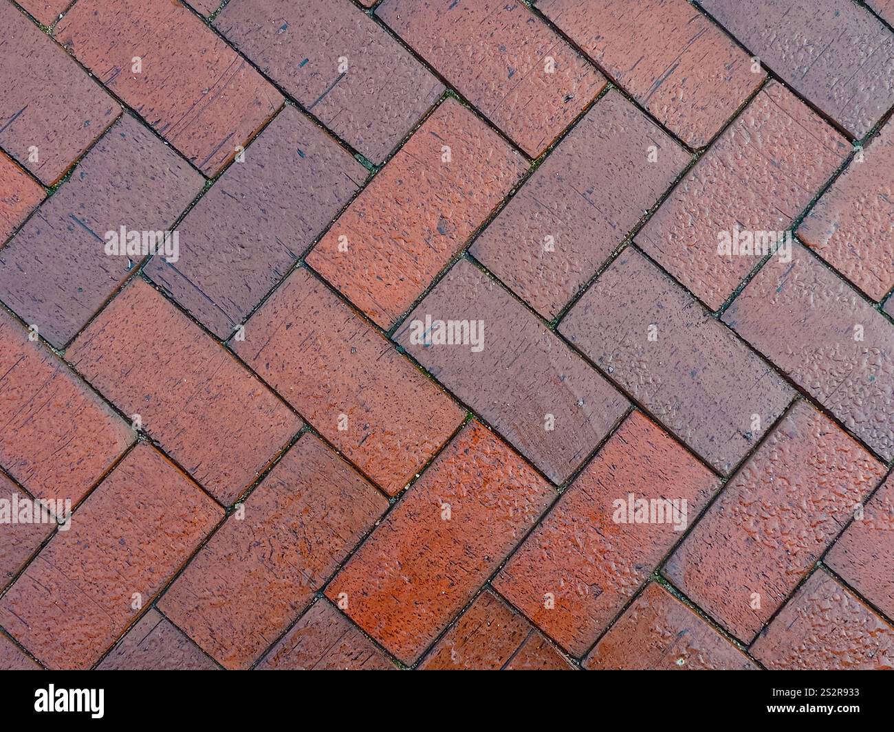 Herringbone brick pattern with red and brown bricks, showcasing a ...