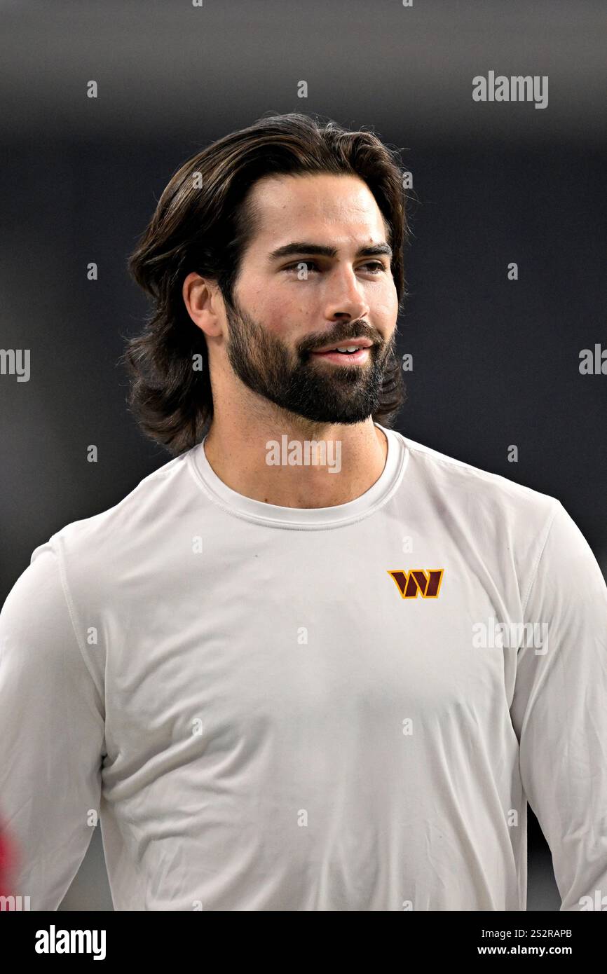 Washington Commanders quarterback Sam Hartman walks on the field before ...