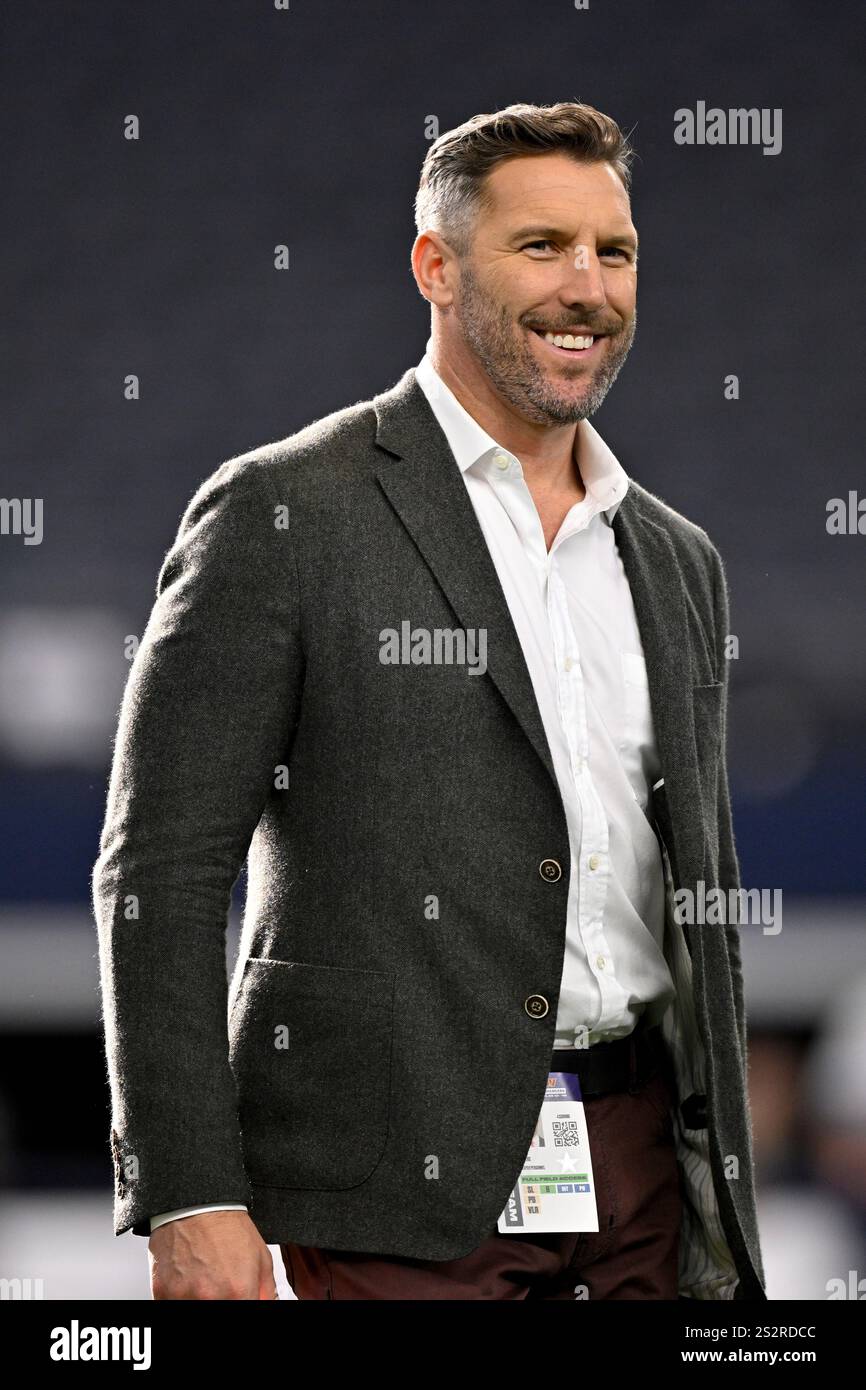 Washington Commanders general manager Adam Peters walks on the field ...
