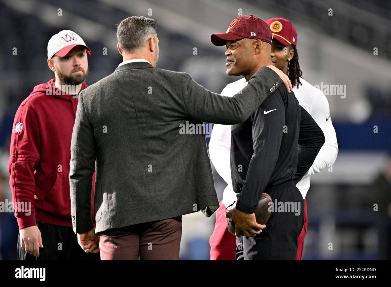 Washington Commanders general manager Adam Peters (left) talks with ...