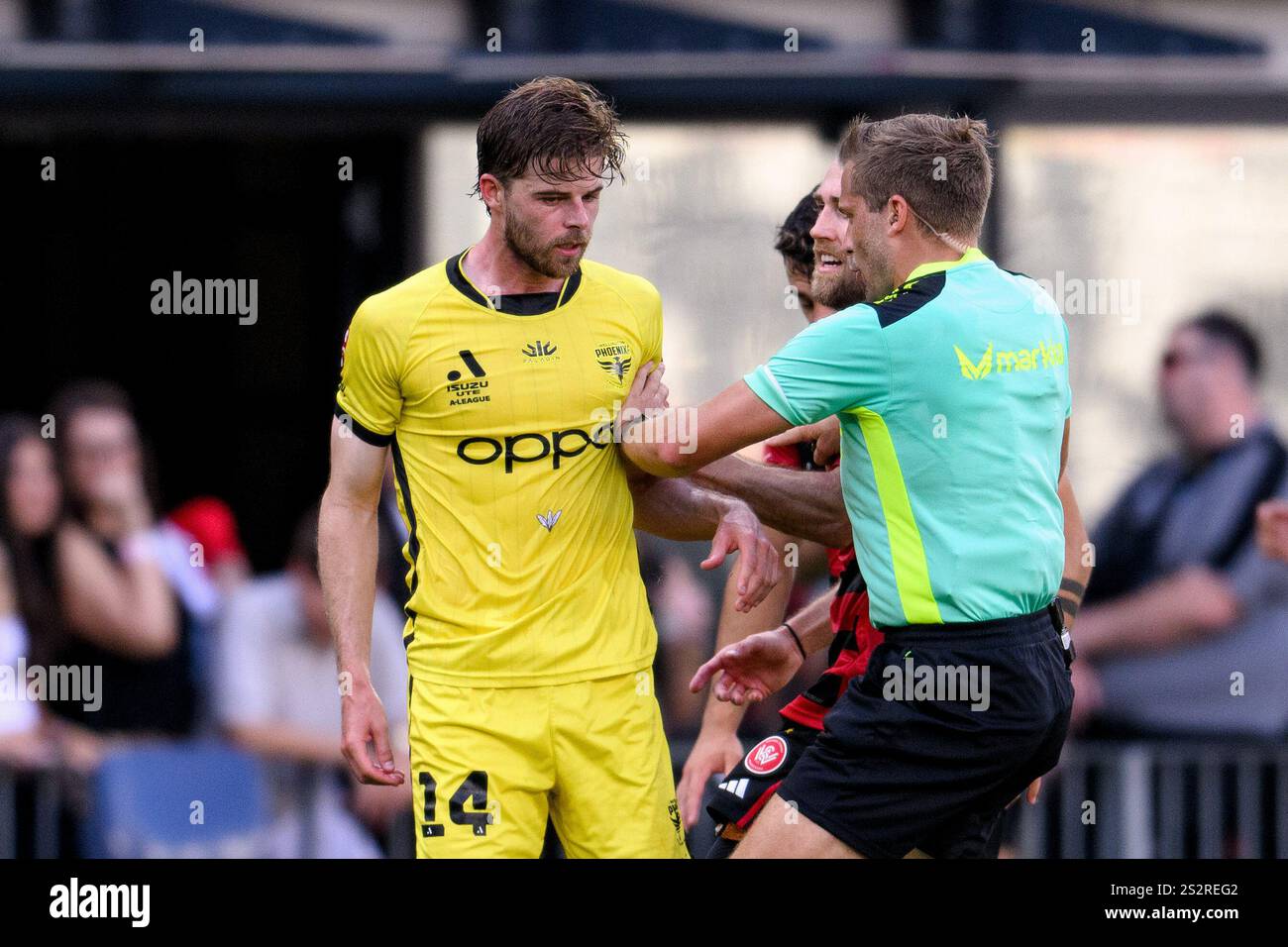 Referee pushes Alex Rufer of Wellington Phoenix during the A-League Men ...