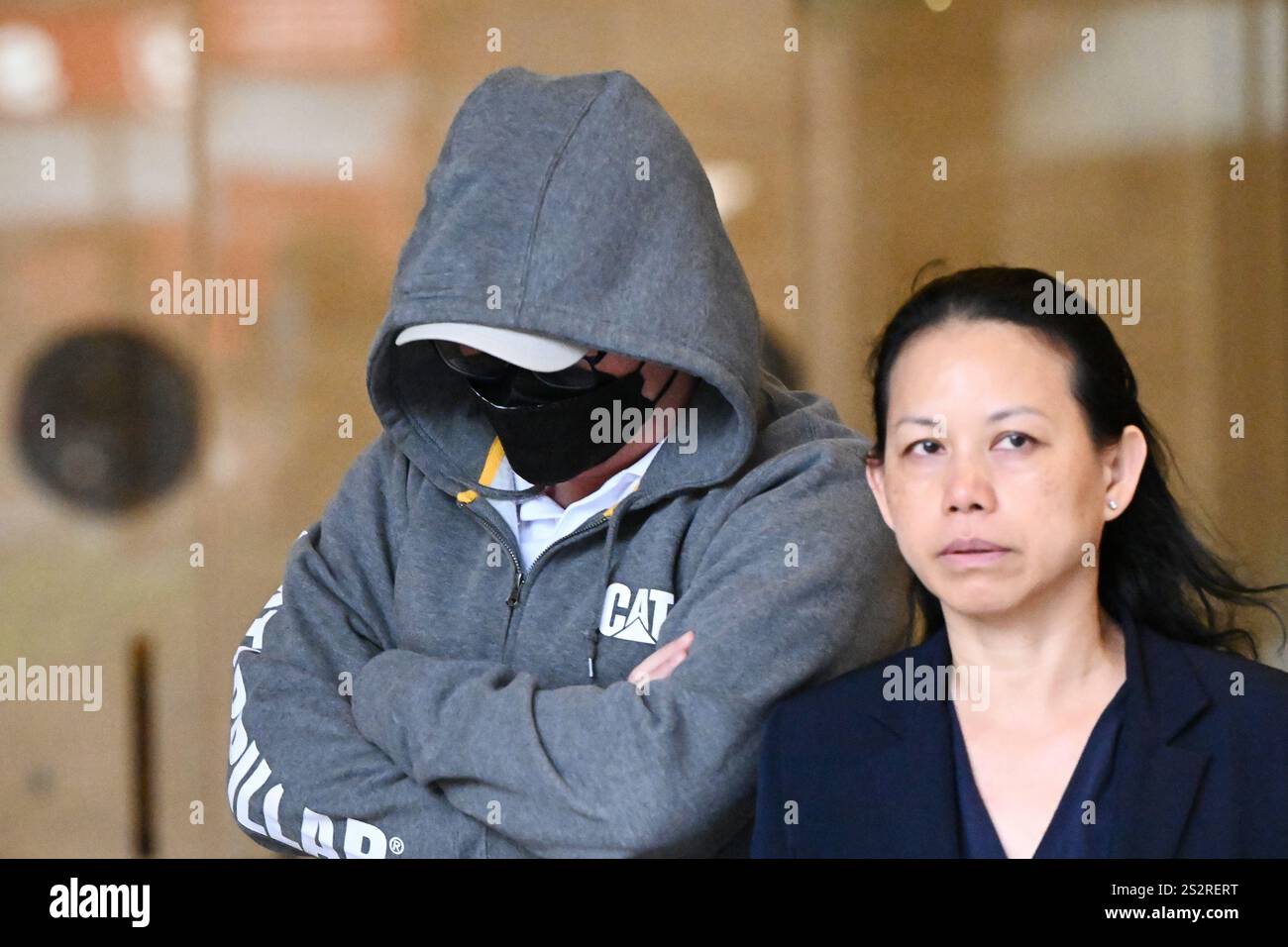 Surya Subekti (left) departs the Downing Centre Court, Sydney, Tuesday ...