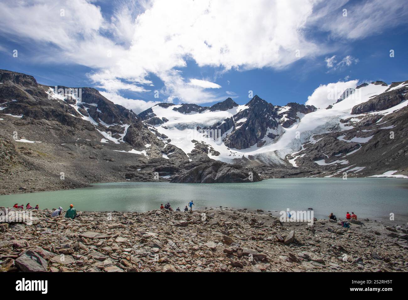 Hikers looking across the Laguna de los Tempanos with the Vinciguerra ...