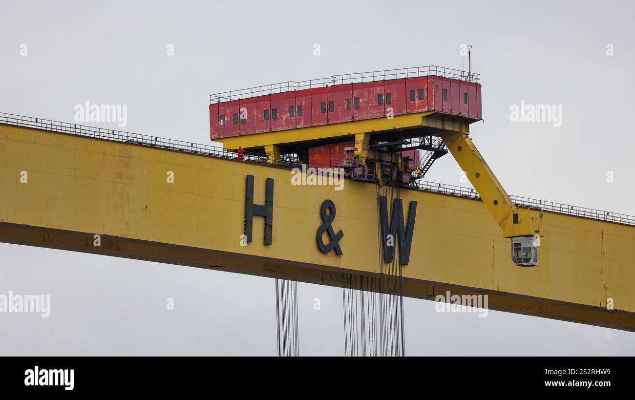 Close-up Harland & Wolff yellow shipyard crane with crane operators ...