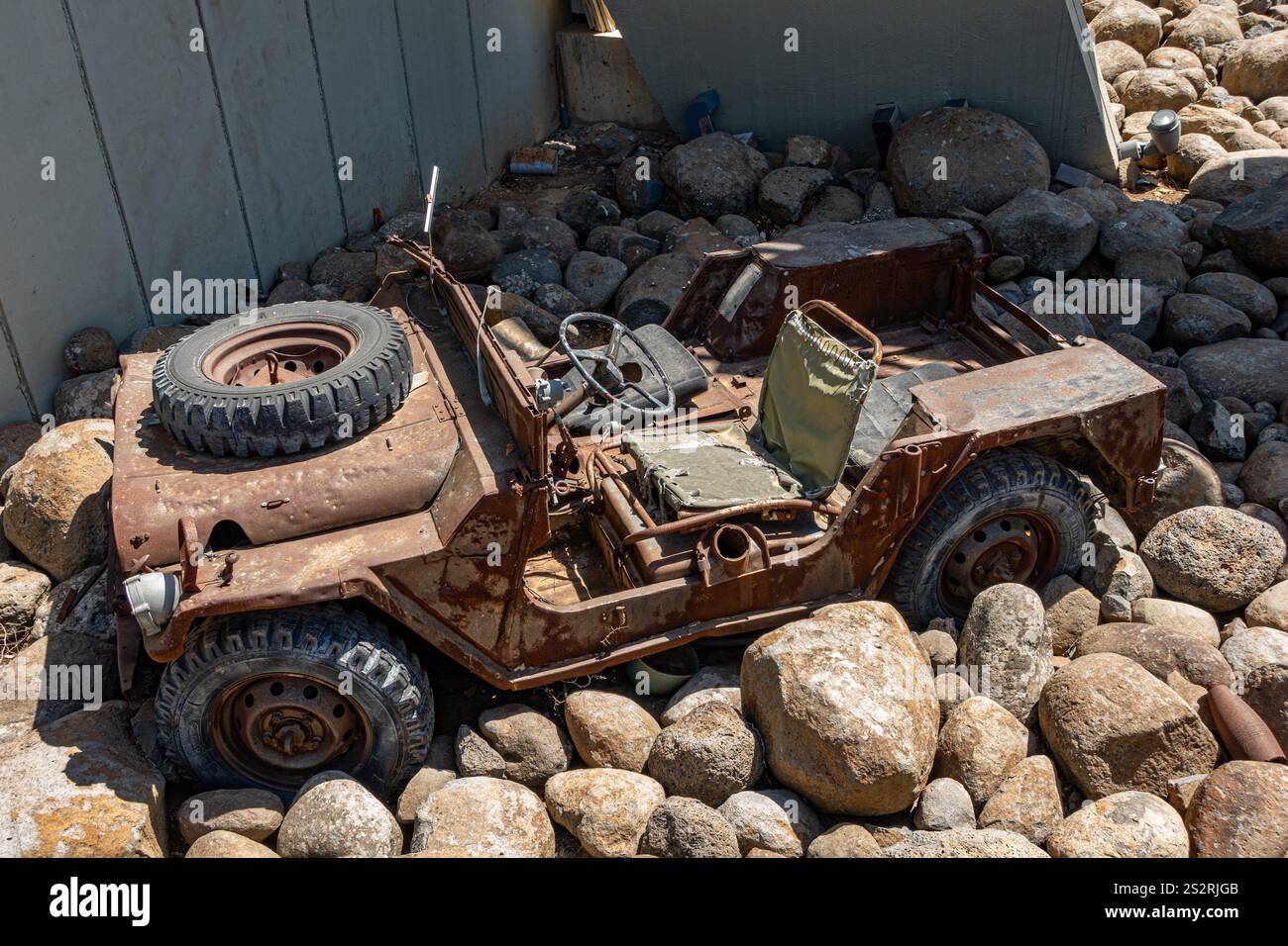 A rusty toy jeep, once bright and shiny, is now sitting atop a ...